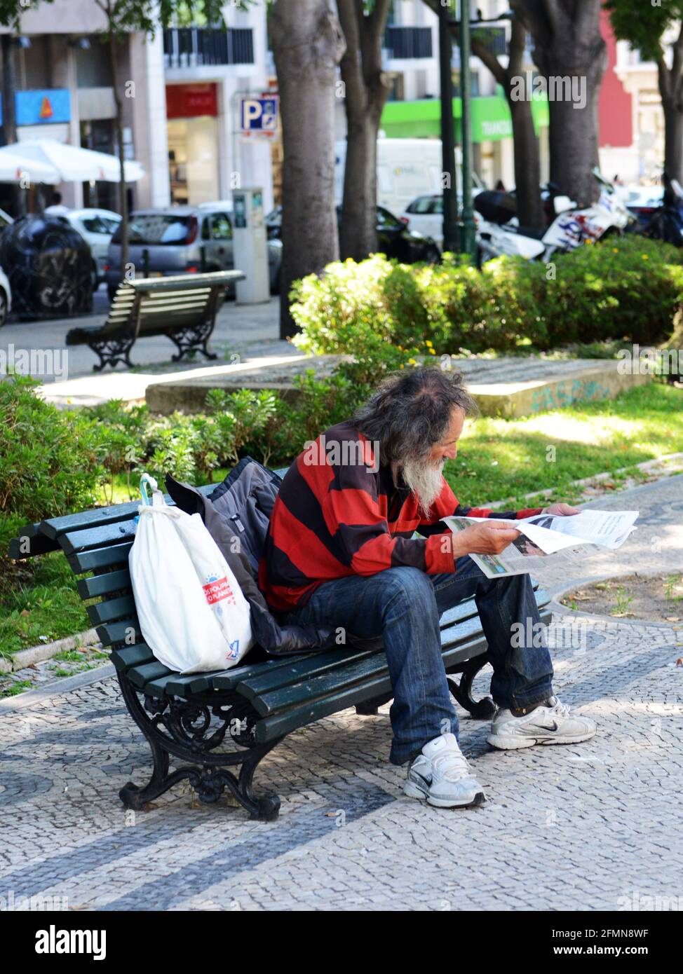 Homeless man sitting on city hi-res stock photography and images - Alamy