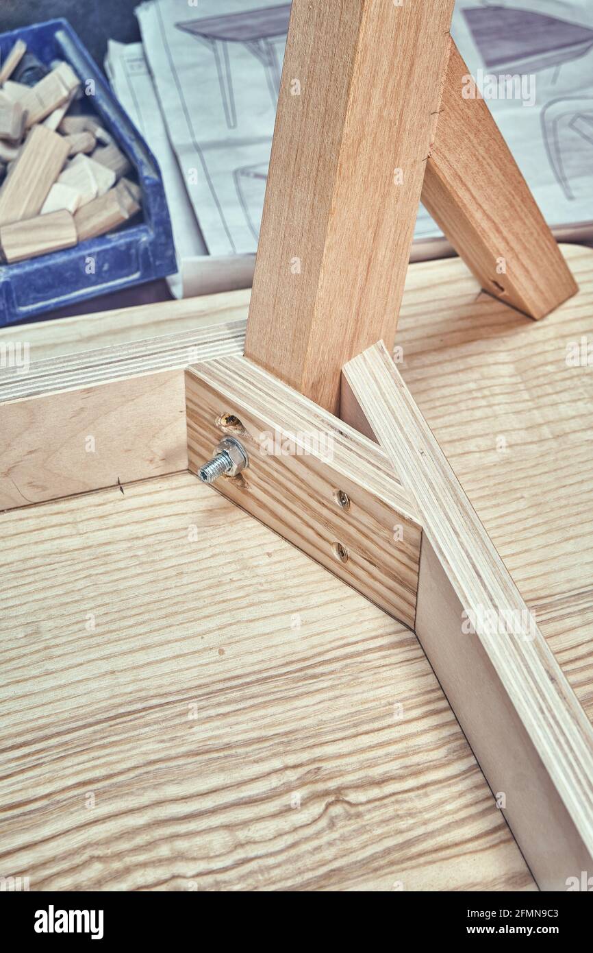 Corner of upside-down stylish new table of plywood, veneer and solid ...