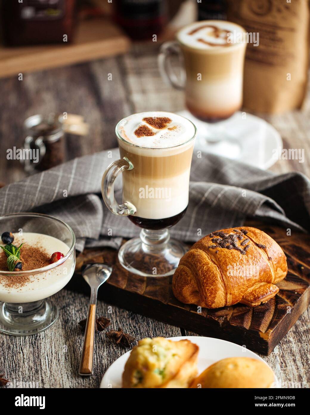 Coffee cafe table with desserts and latte drinks Stock Photo - Alamy