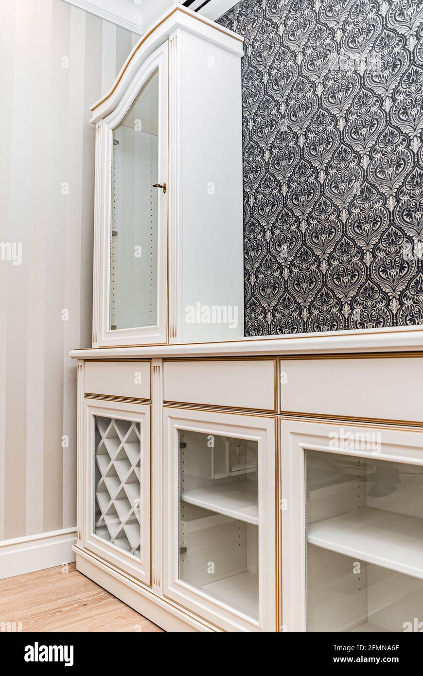 Classical style white showcase with glass doors and gilding on the ...