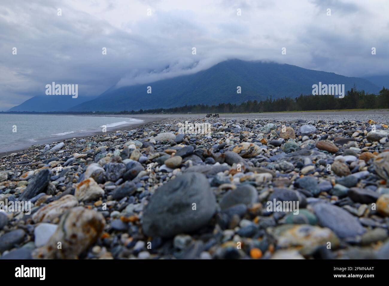 Beautiful scenic of ocean with stone covered beach at Manbo beach ...
