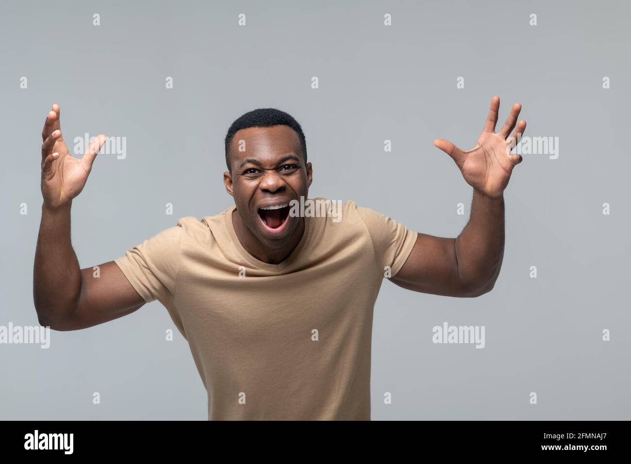 Emotional dark skinned man in cheerful mood Stock Photo - Alamy