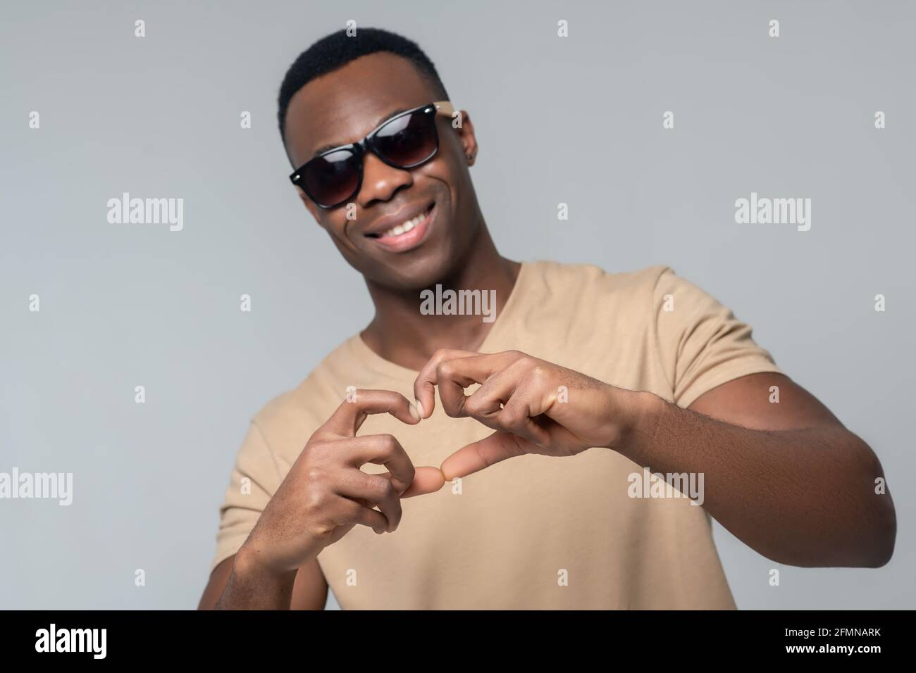 Man showing heart sign with hands Stock Photo - Alamy