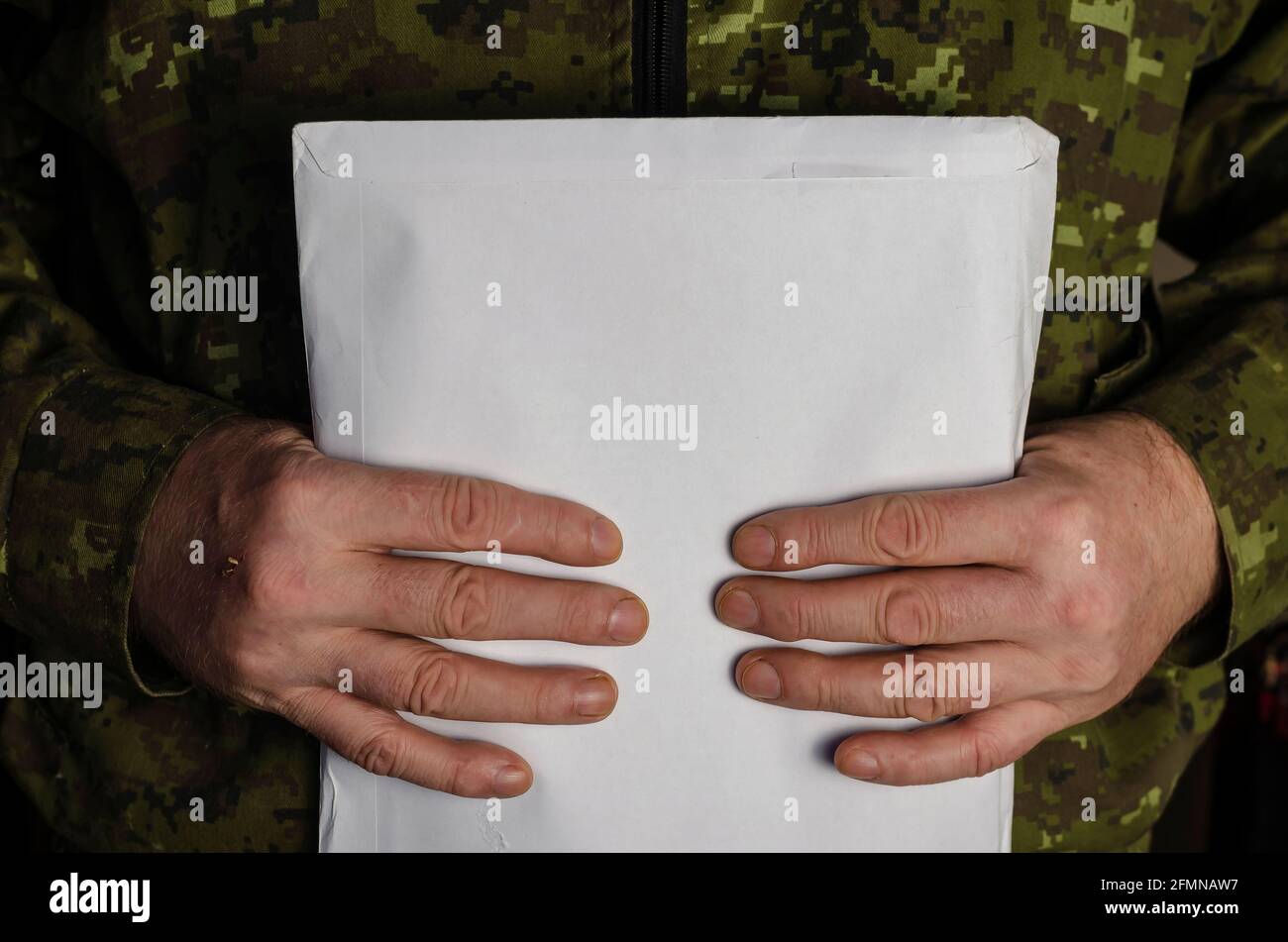 A military man is holding a Large Mail Package. Sealed paper envelope ...