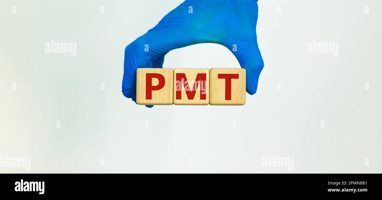 Medical and PMT, premenstrual tension symbol. Hand in blue glove holds ...