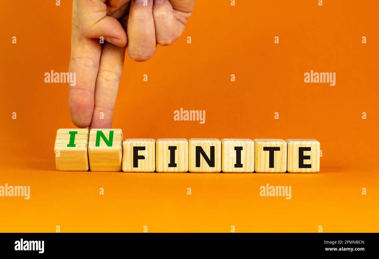 Finite or infinite symbol. Businessman turns wooden cubes and changes ...