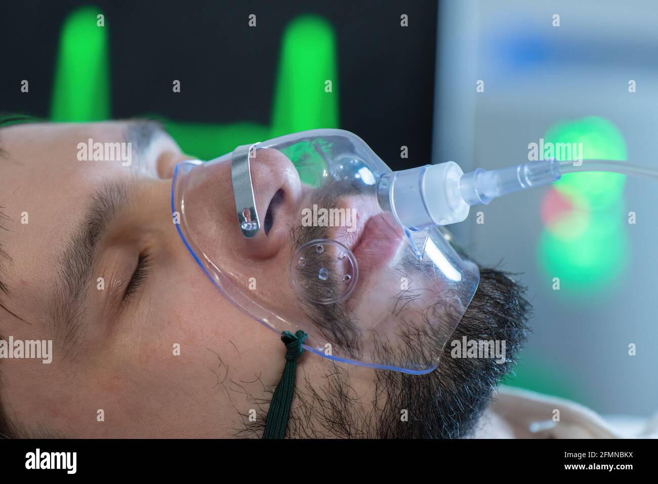 Young man is breathing with oxygen mask on face in hospital during ...