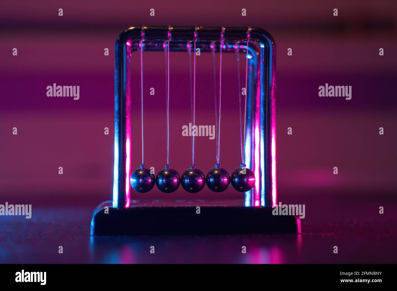 Newton cradle. Demonstrating gravity, action and reaction principle in ...