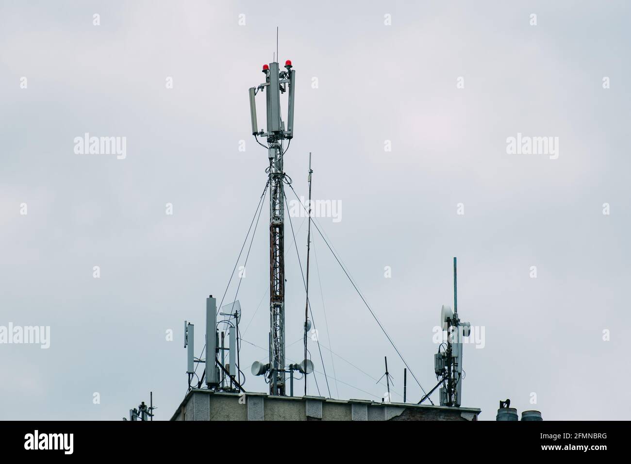 Mobile antennas are located on the roof of the house. on a background ...