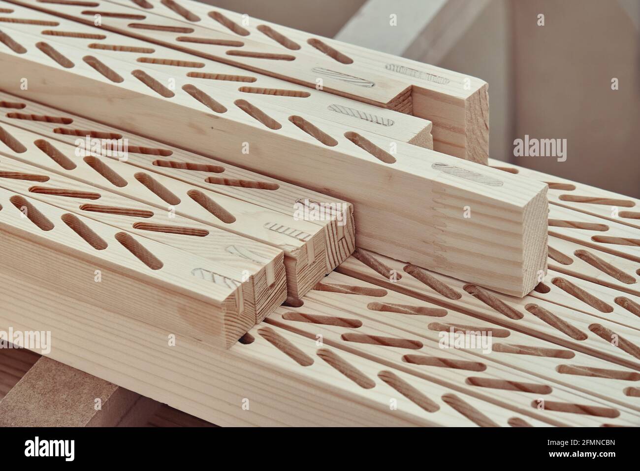 New processed wooden bars with lines of slots to install thin planks ...