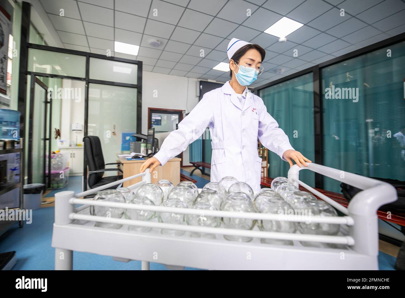 BIJIE, CHINA - MAY 11, 2021 - A nurse carries TCM instruments at a TCM ...