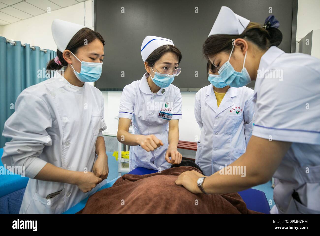 BIJIE, CHINA - MAY 11, 2021 - A nurse demonstrates the meridian patting ...
