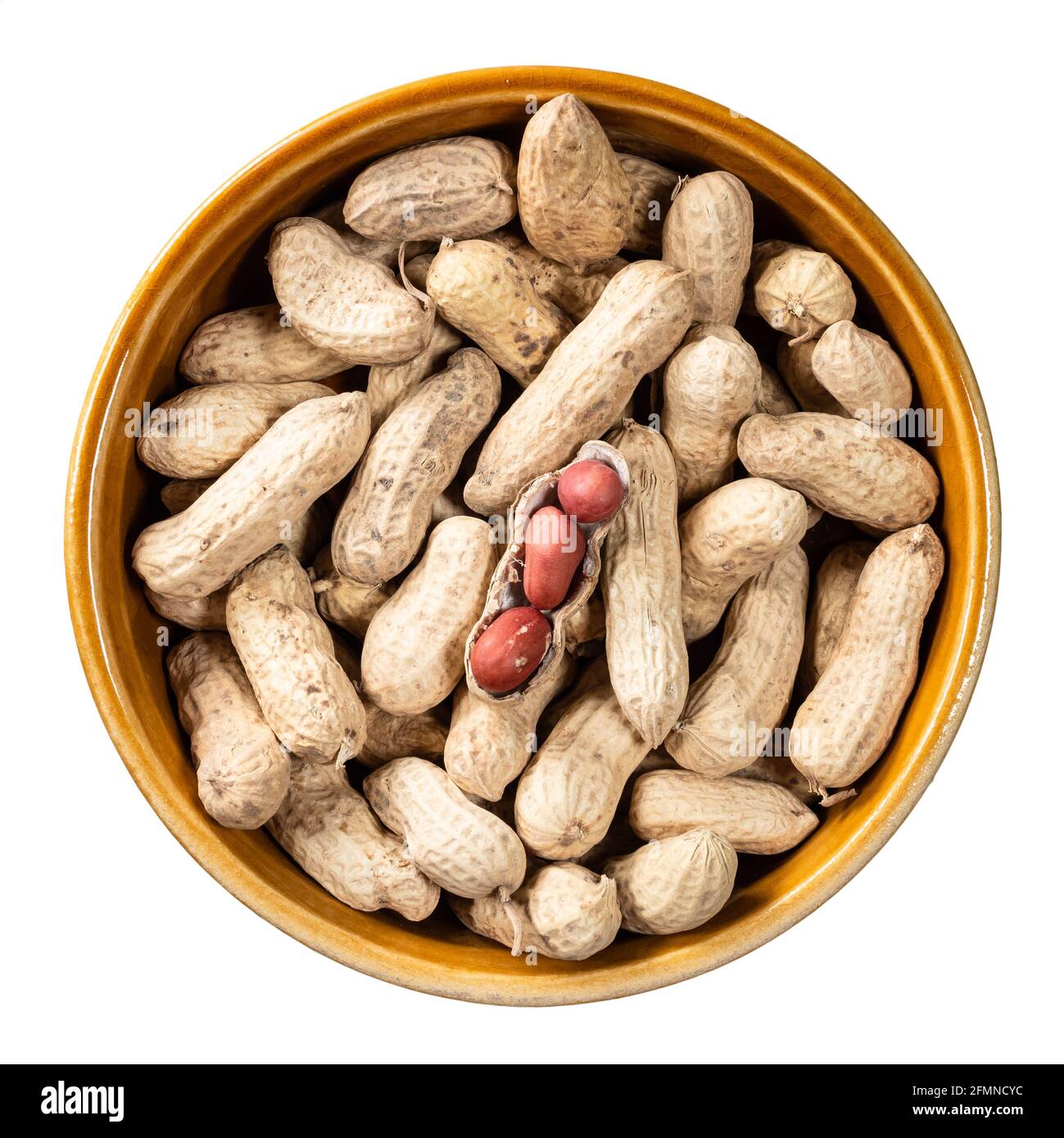 top view of raw peanuts in round ceramic bowl cutout on white ...