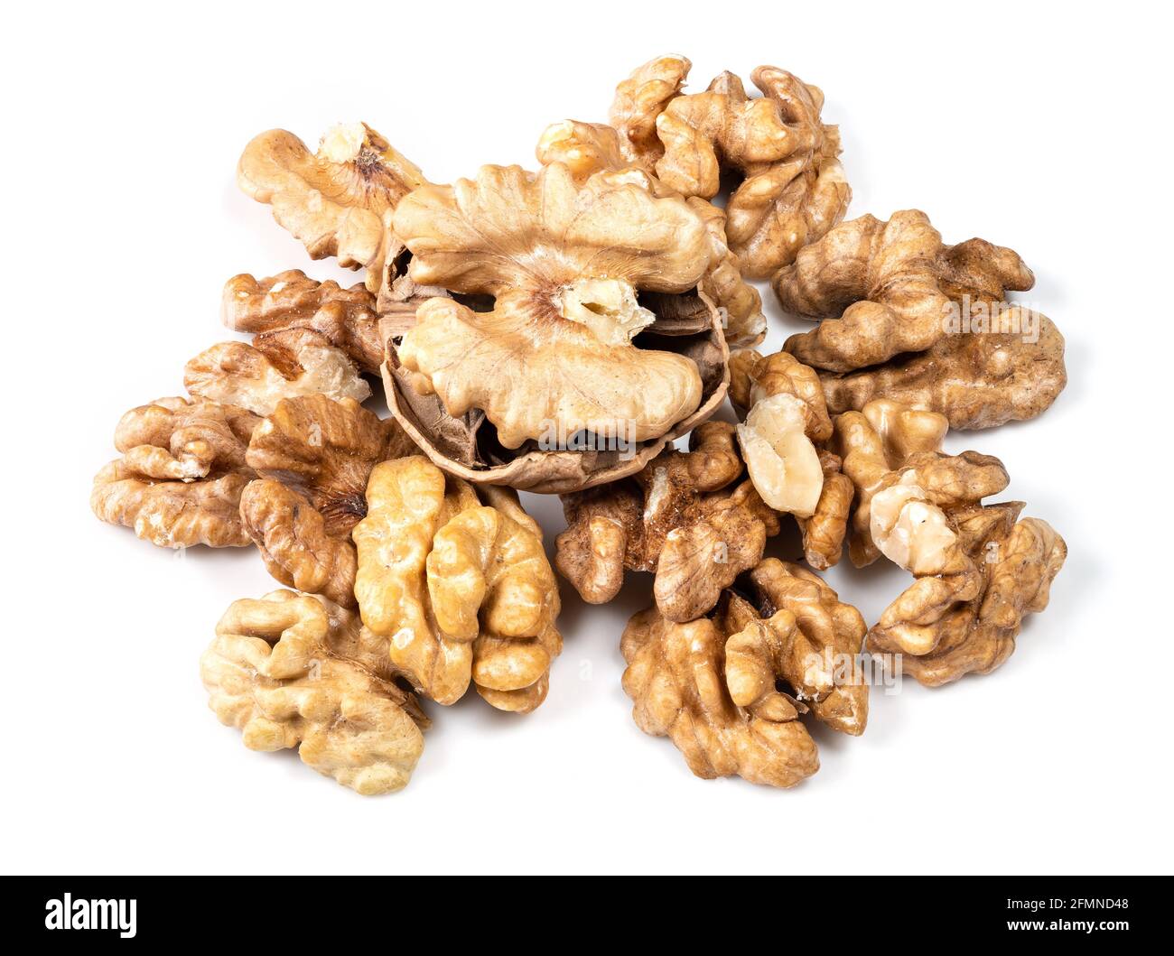 pile of shelled and cracked walnuts closeup on white background Stock ...