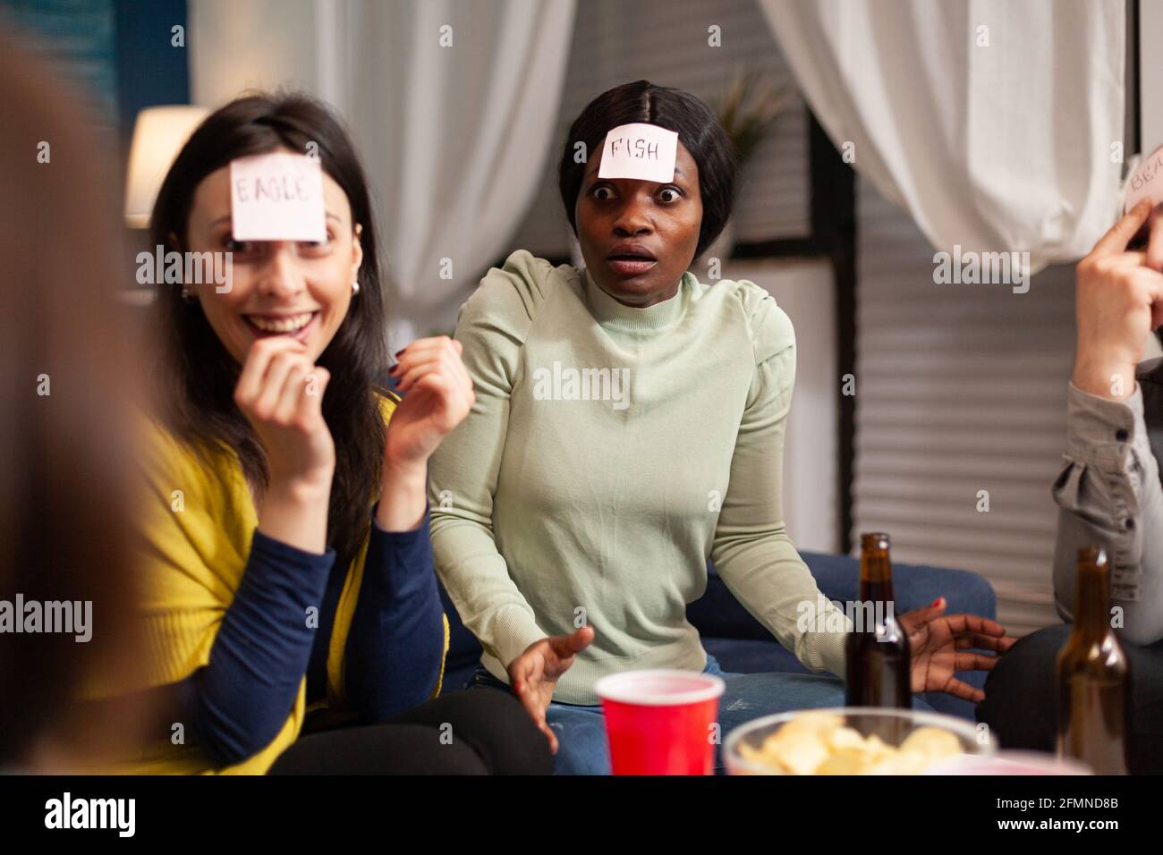 Group of multi-ethnic people having fun while playing board game using ...