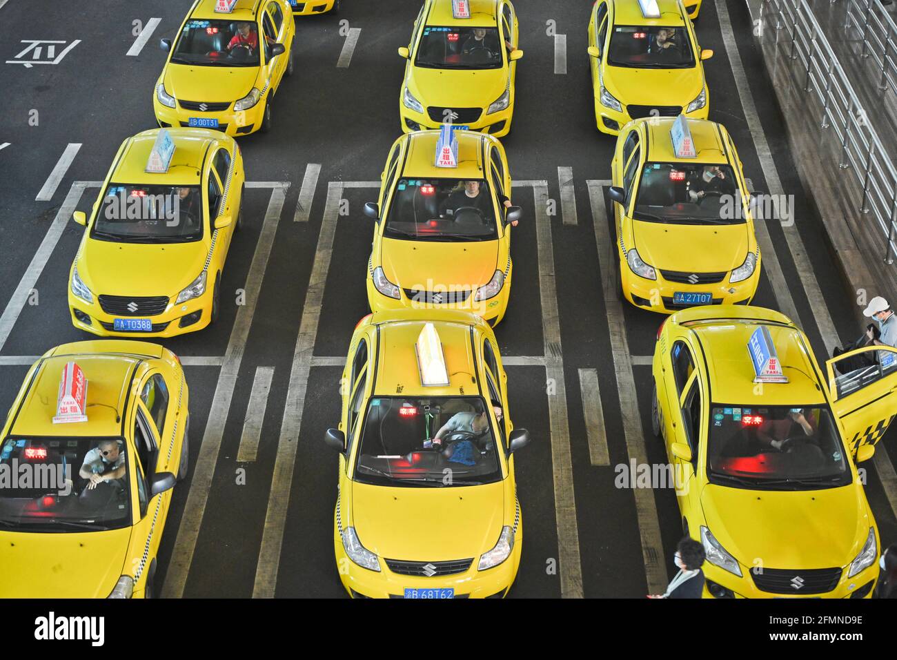 CHONGQING, CHINA - MAY 10, 2021 - A series of taxis line up outside the ...
