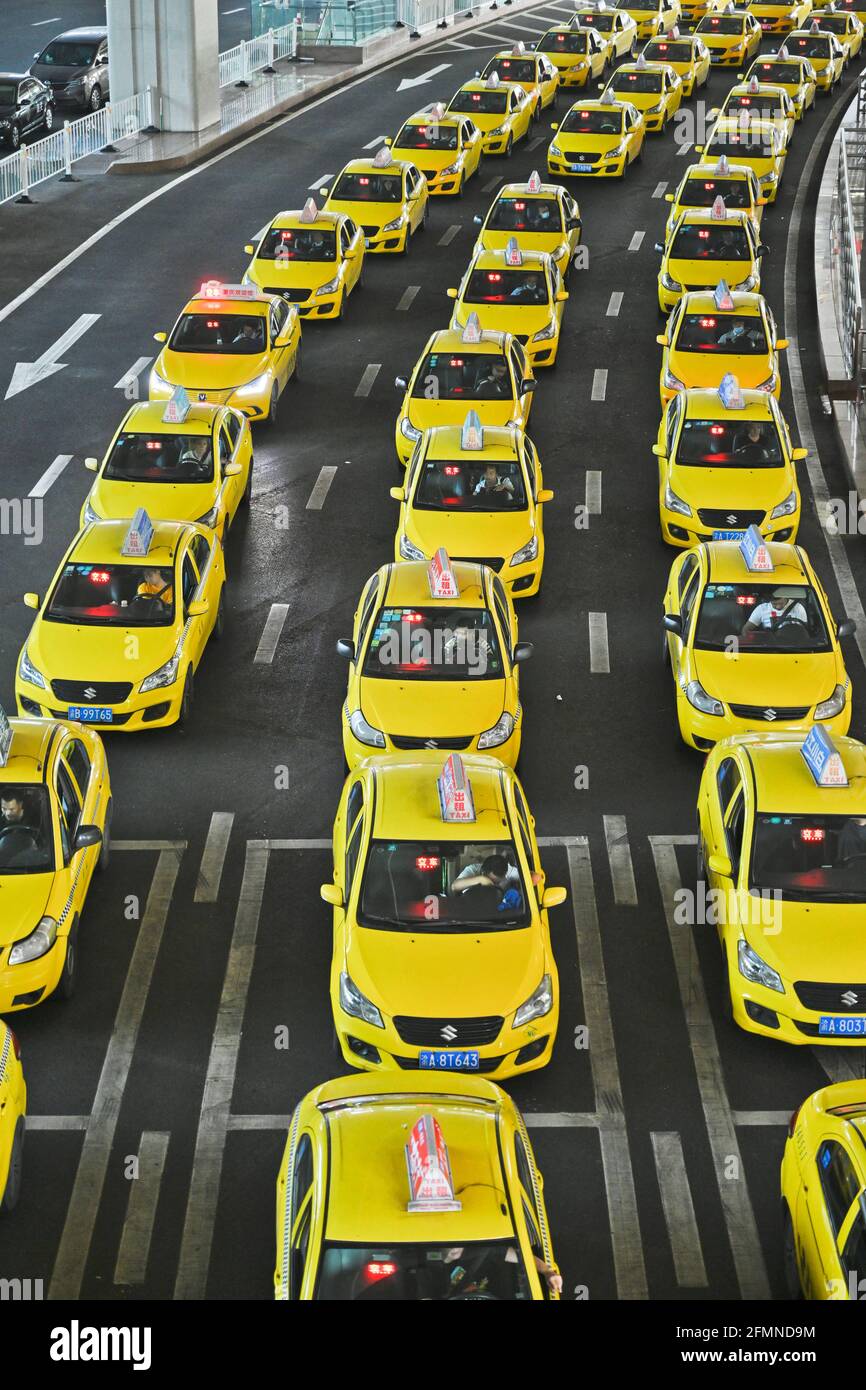 CHONGQING, CHINA - MAY 10, 2021 - A series of taxis line up outside the ...