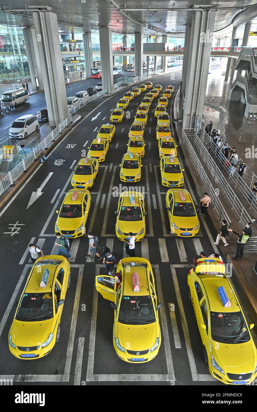 CHONGQING, CHINA - MAY 10, 2021 - A series of taxis line up outside the ...