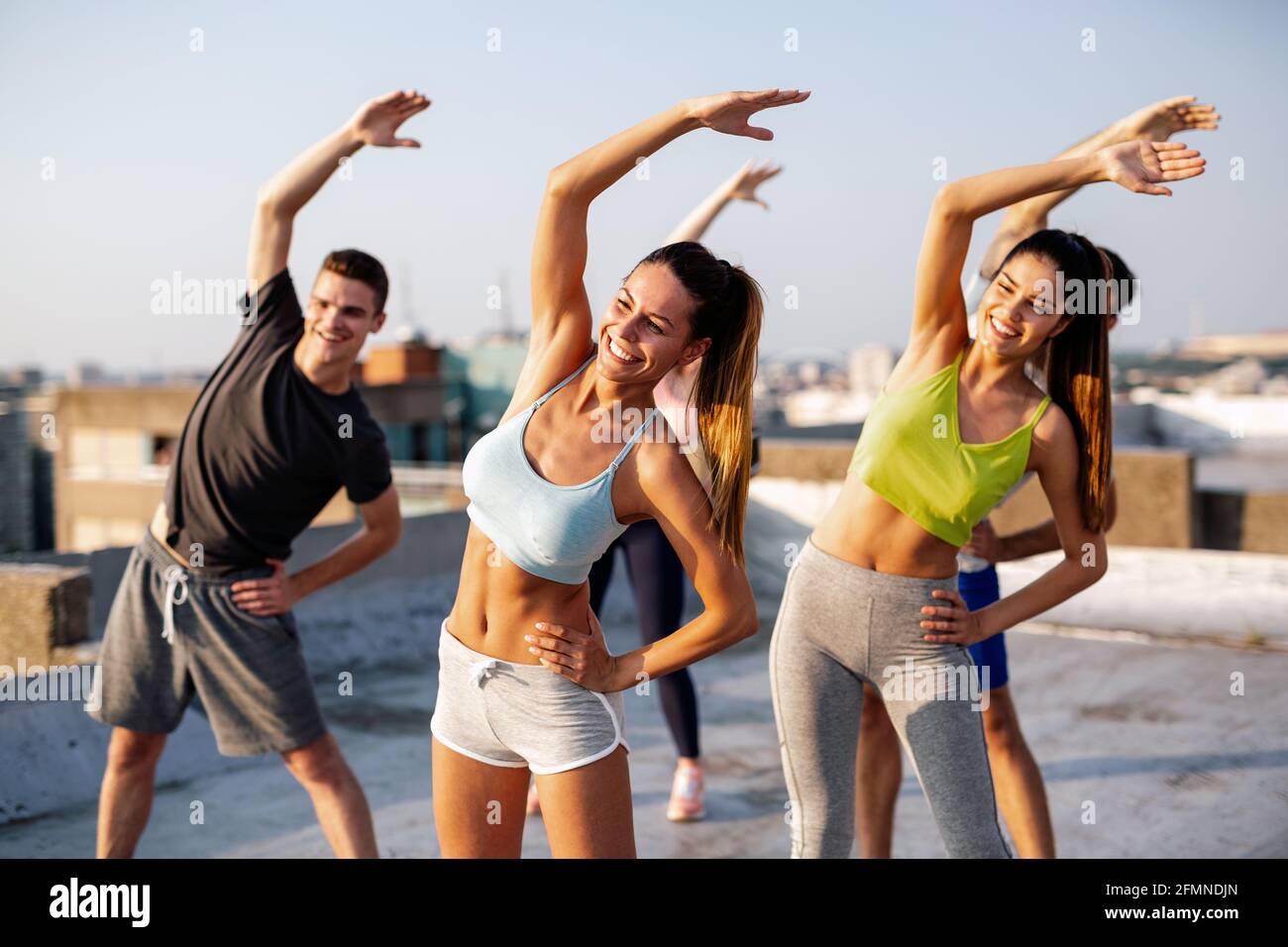 Group of happy fit people friends exercising together outdoor Stock ...