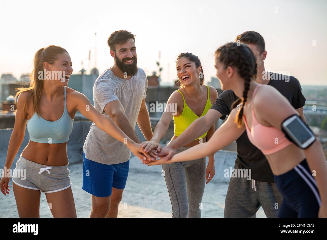 Group of happy fit people friends exercising together outdoor Stock ...