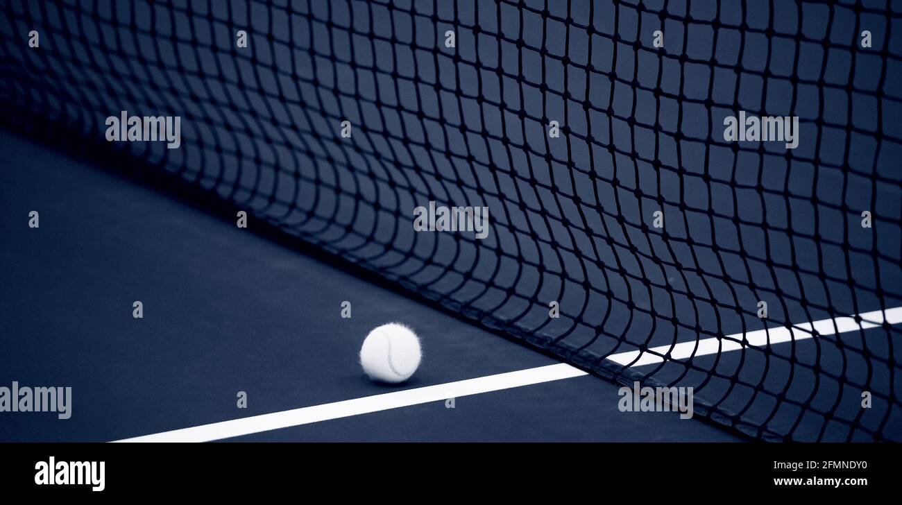 Tennis net and ball and hard court. Professional sport and tennis ...