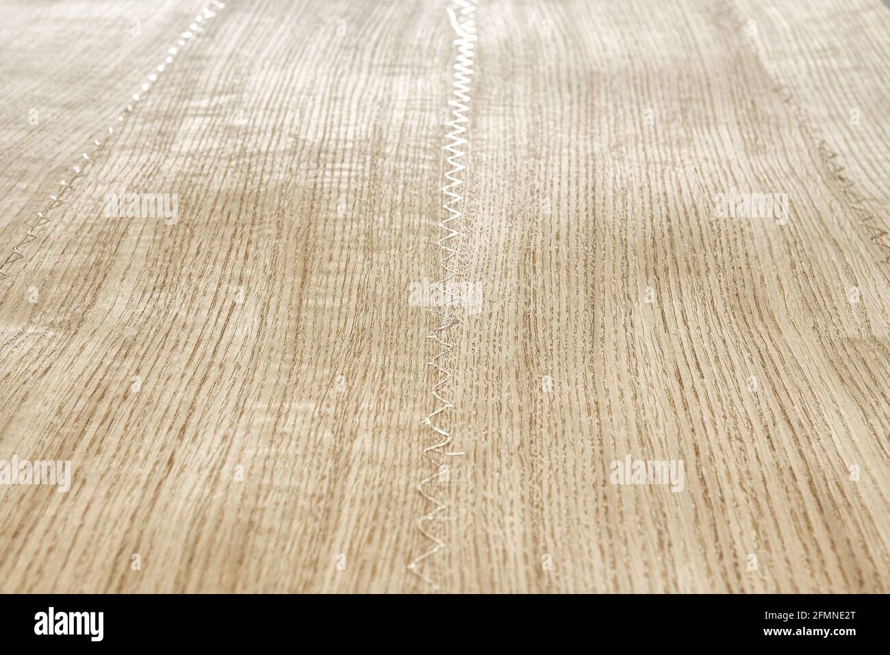 Oak texture as background. Spliced oak veneer with glue thread for ...