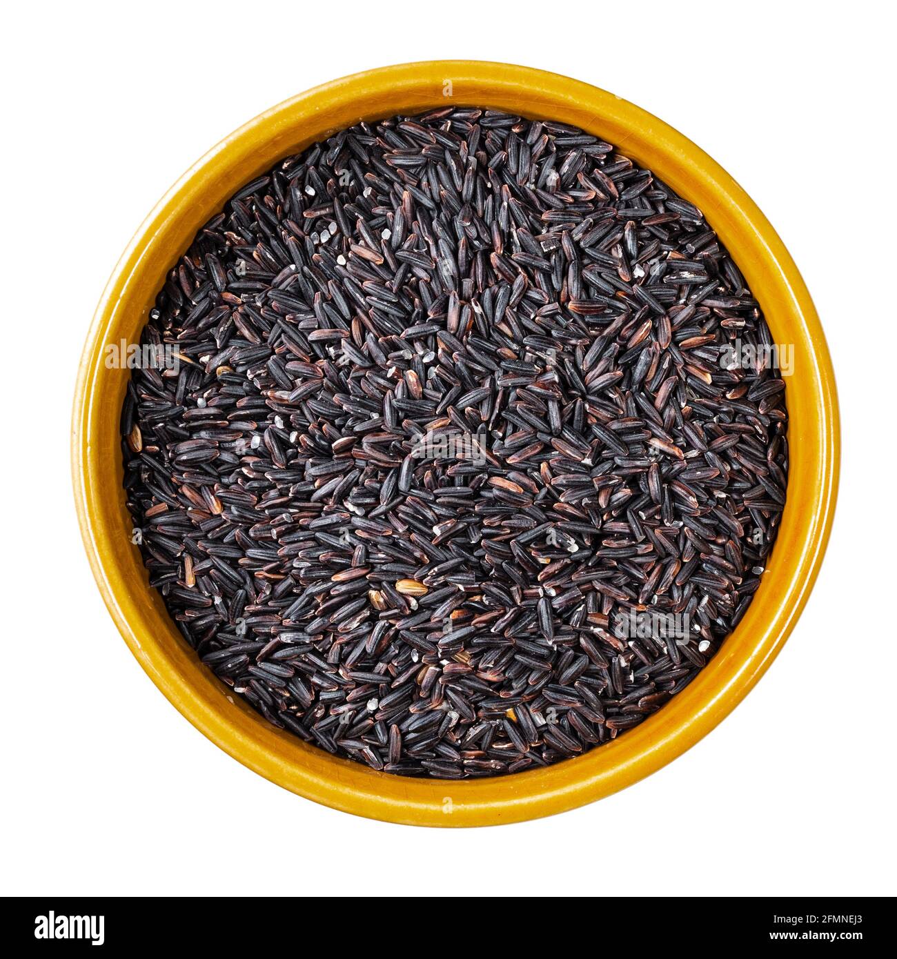 top view of raw black rice in round bowl cutout on white background ...