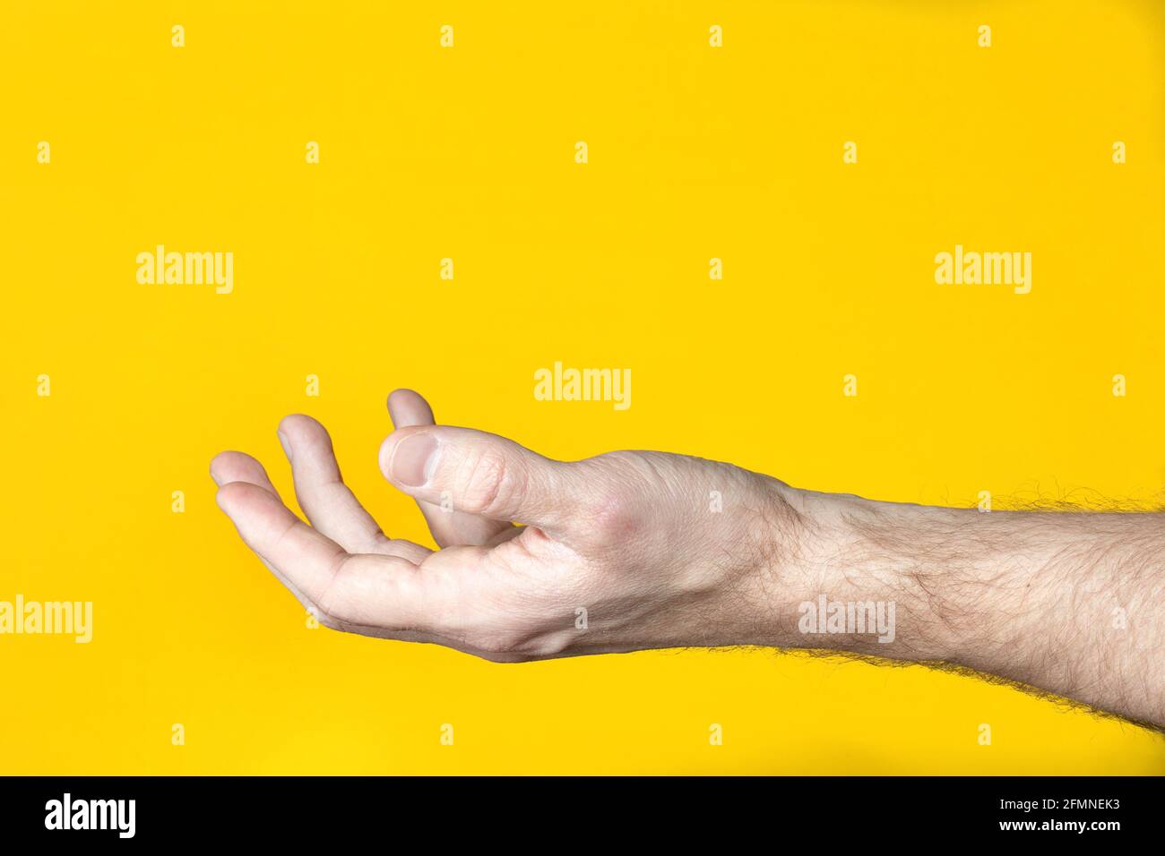 Man hand holding or taking something on yellow background Stock Photo ...