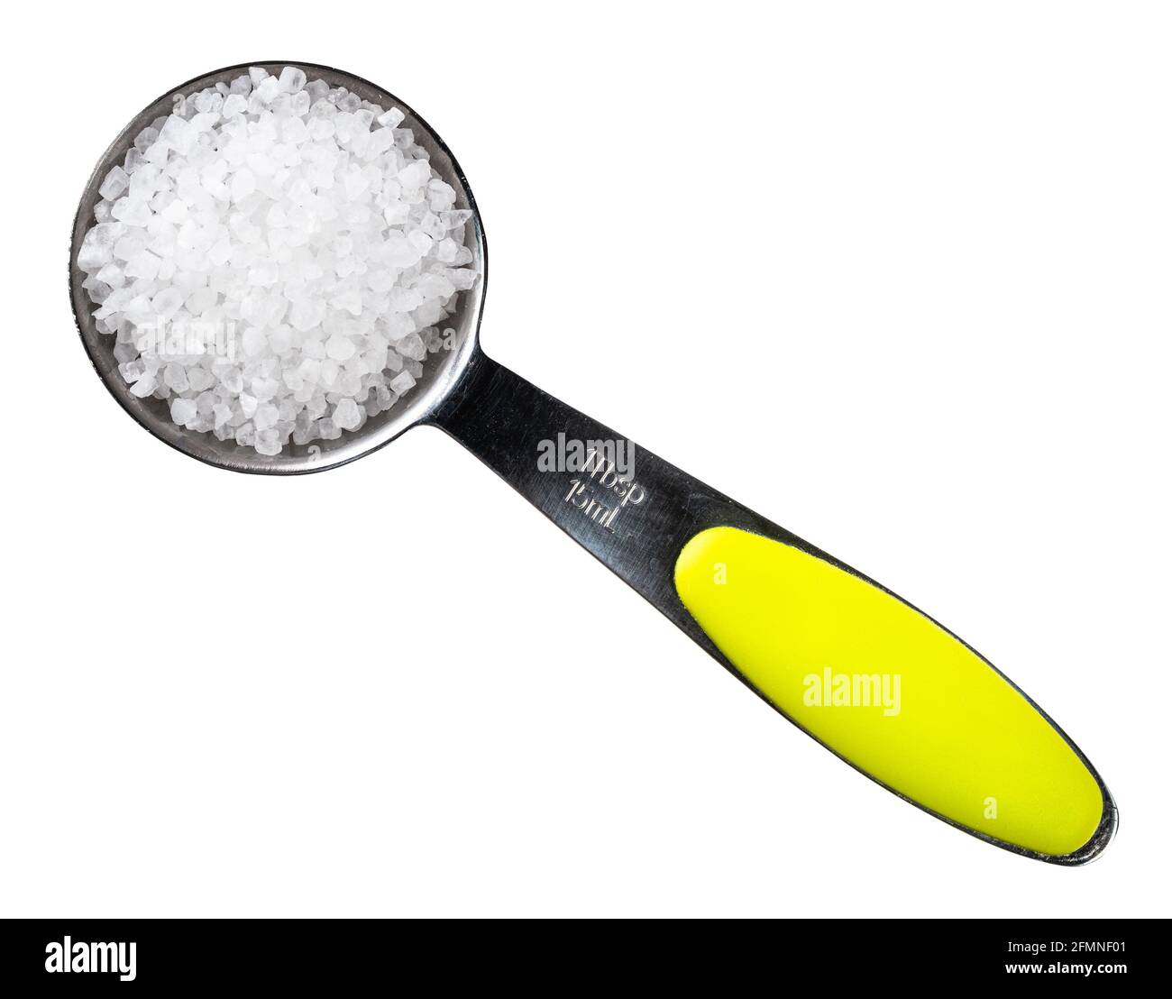 top view of coarse sea salt in measuring tablespoon cutout on white ...