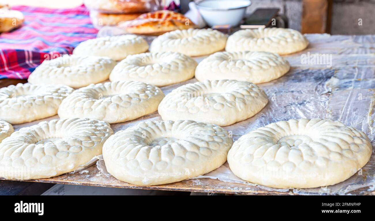 Traditional uzbek round flat bread is preparing to put in the tandyr ...