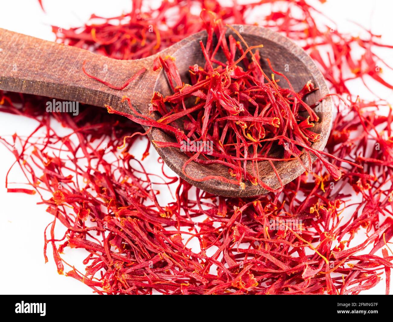 wooden spoon on pile of natural saffron threads closeup Stock Photo - Alamy