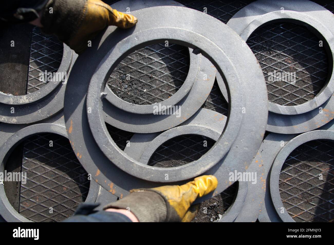 worker and newly manufactured pulleys Stock Photo - Alamy