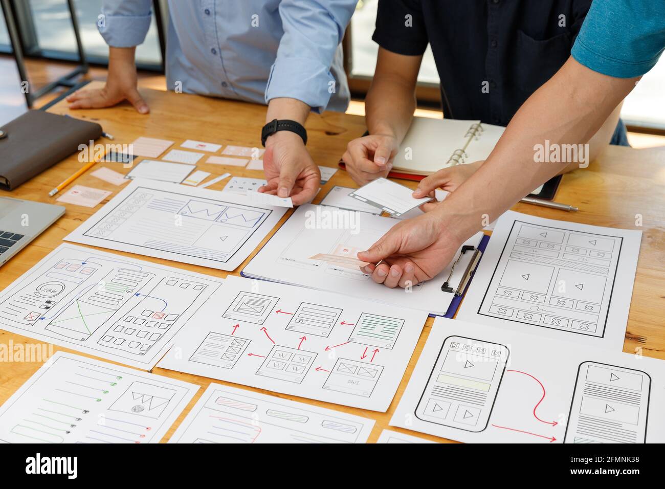 Graphic designers work together with UX UI designer planning ...
