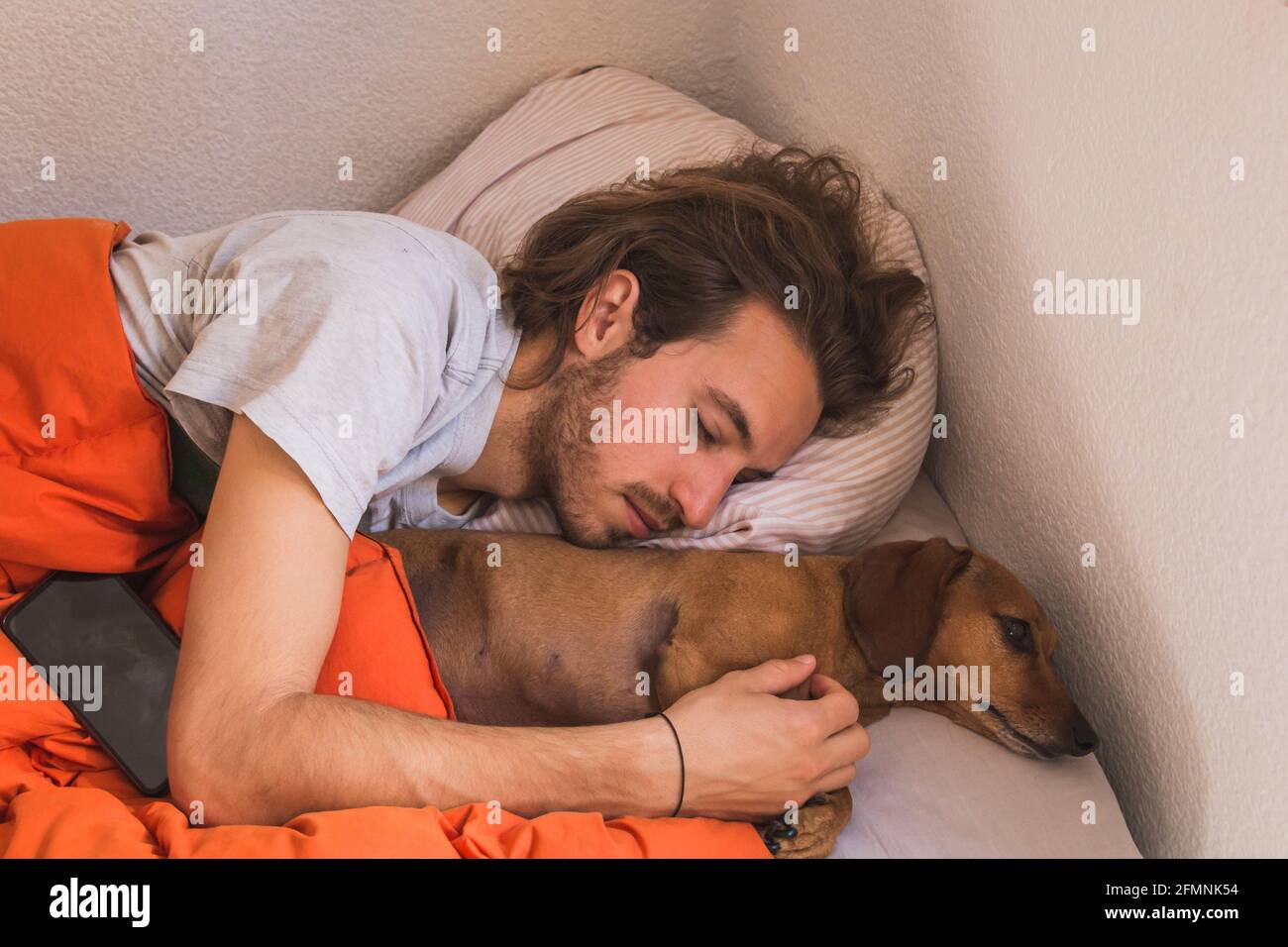 man sleeping with dog Stock Photo - Alamy