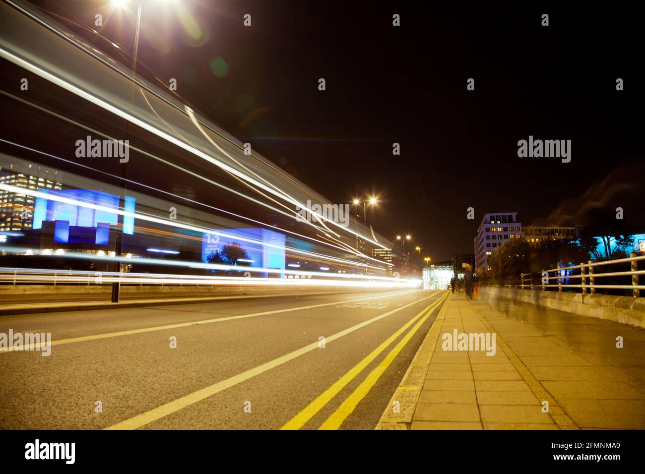 Long exposure picture people and traffic crossing a bridge at night ...
