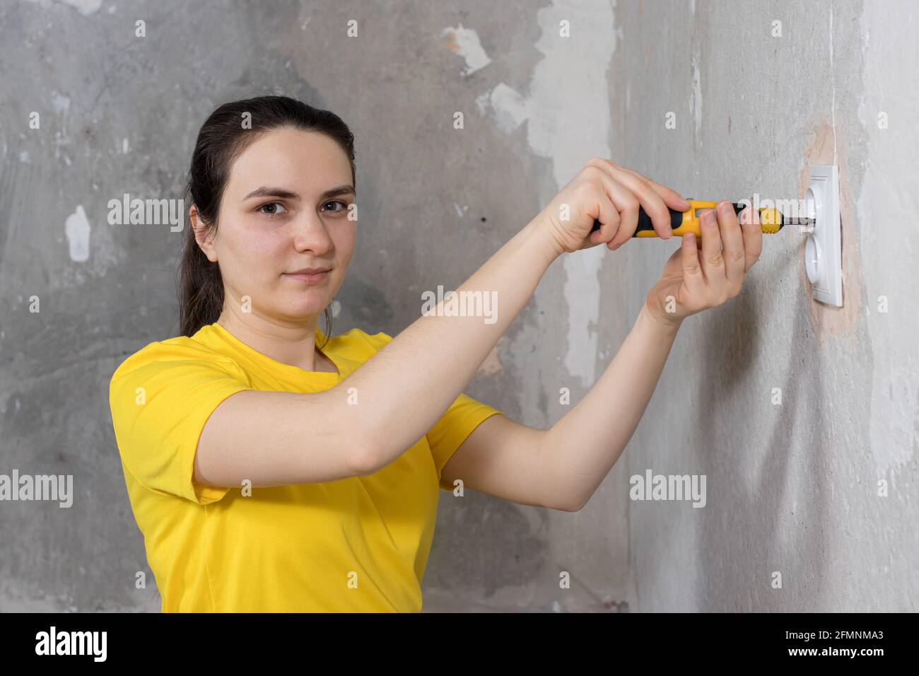 Woman repairs electric socket hi-res stock photography and images - Alamy