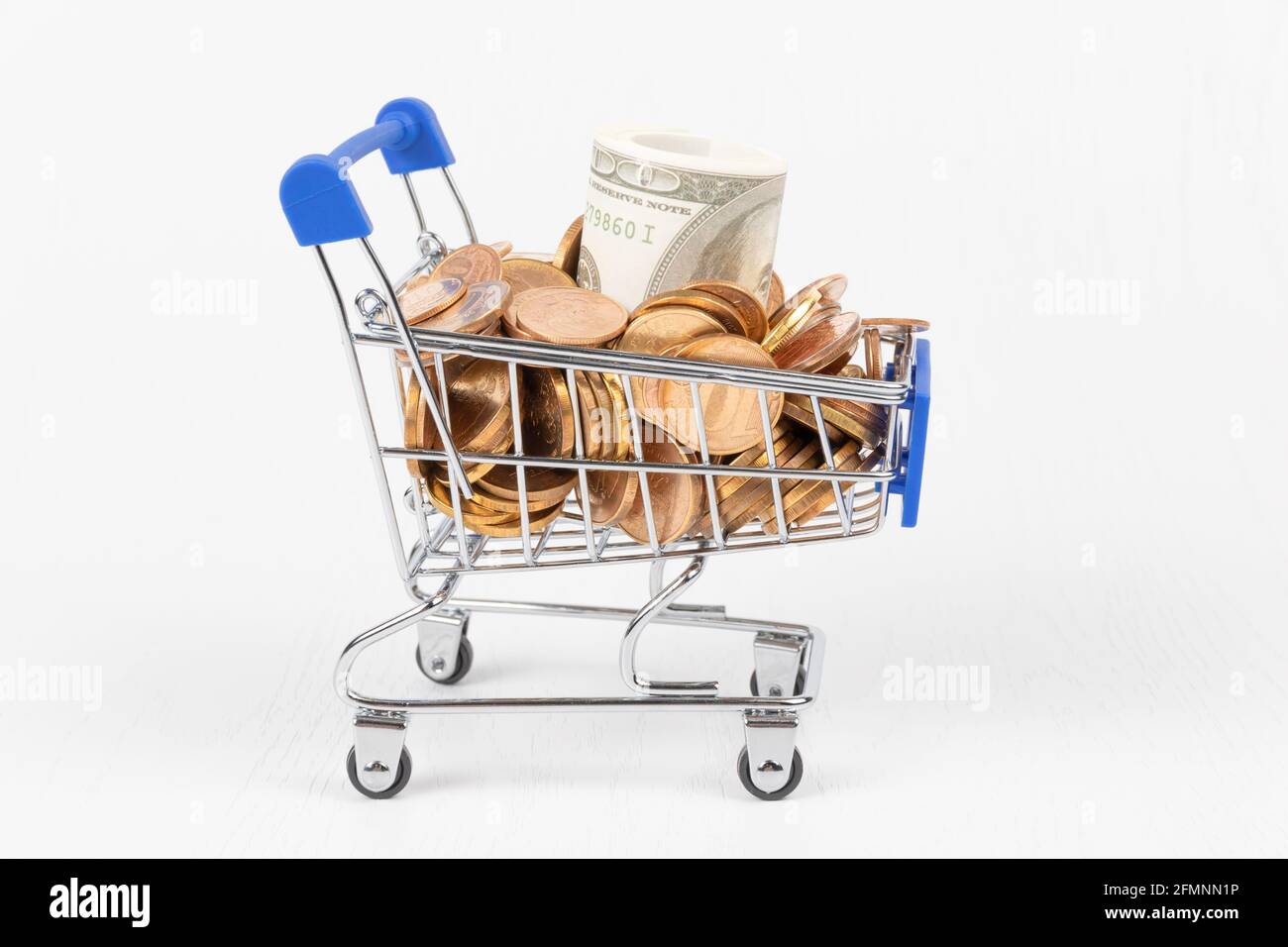 metal chrome shiny shopping trolley on wheels with gold coins and paper ...