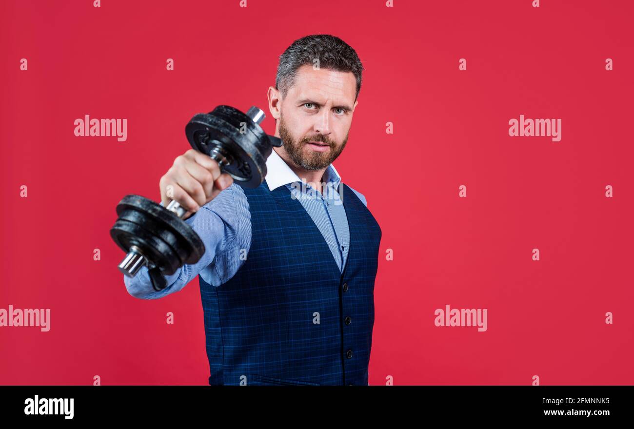 Strong man manager do dumbbell workout red background, business Stock ...