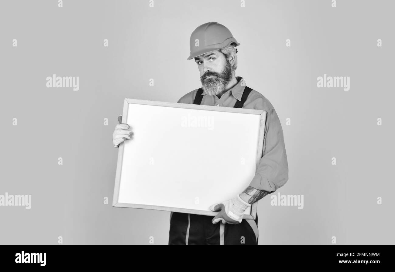 man in hard hat. Builder points to flipchart. Architect worker hold ...