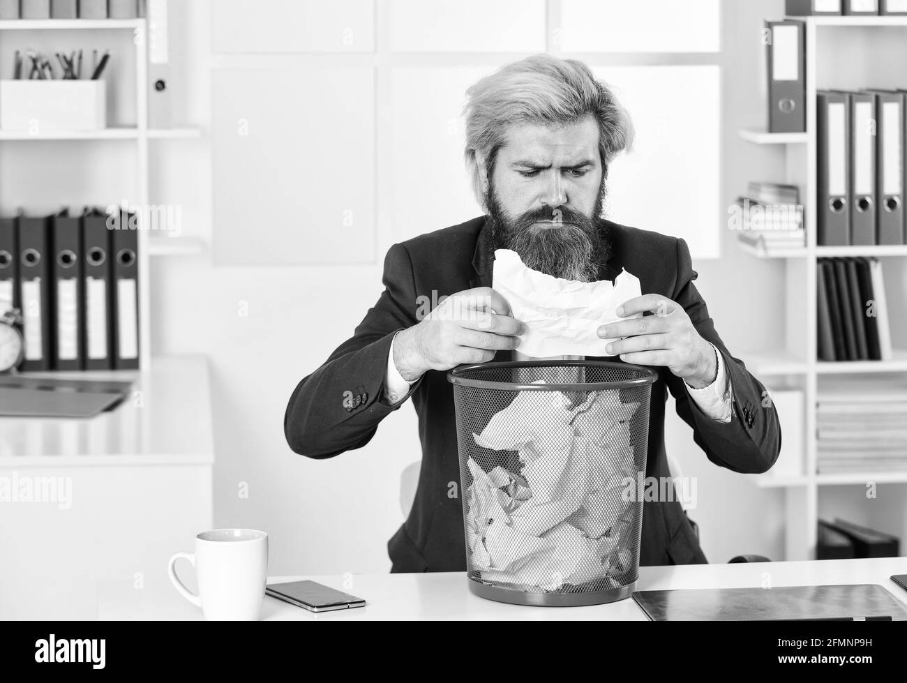 interesting info. man in office look for lost note in paper bin ...