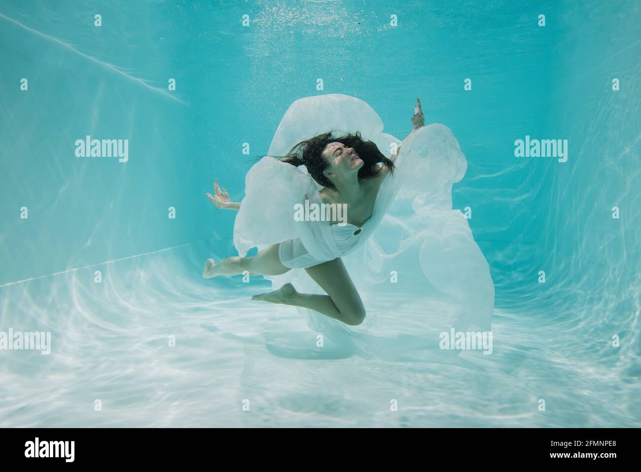 Woman diving into pool and underwater hi-res stock photography and ...