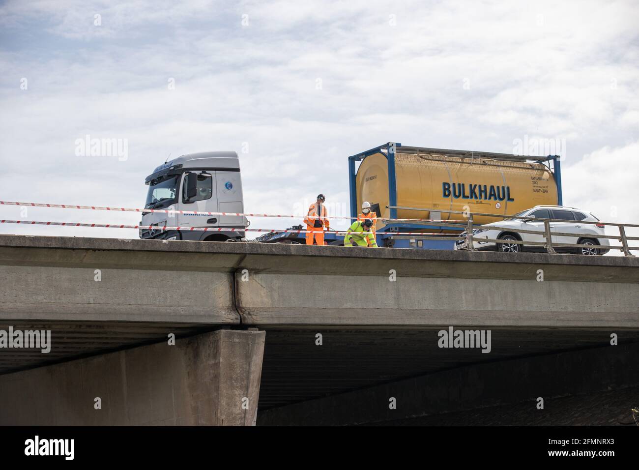 Normanton, UK. 11th May, 2021. Workmen asses the damage of the barrier ...