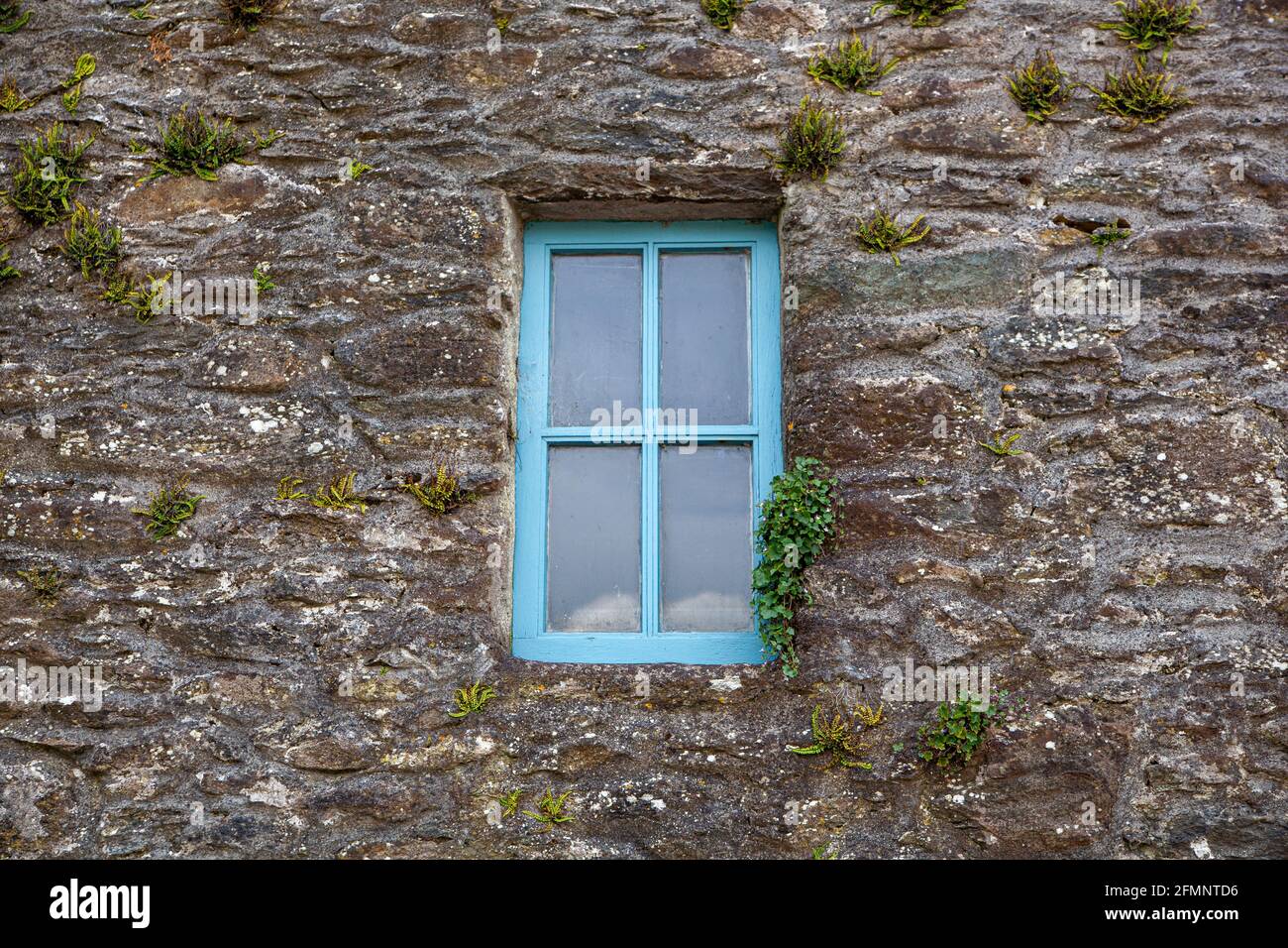 A blue window on a stone facade Stock Photo - Alamy