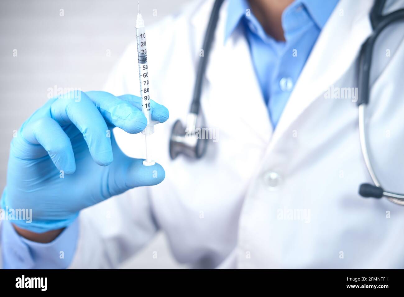 doctor hand in medical gloves holding syringe Stock Photo - Alamy