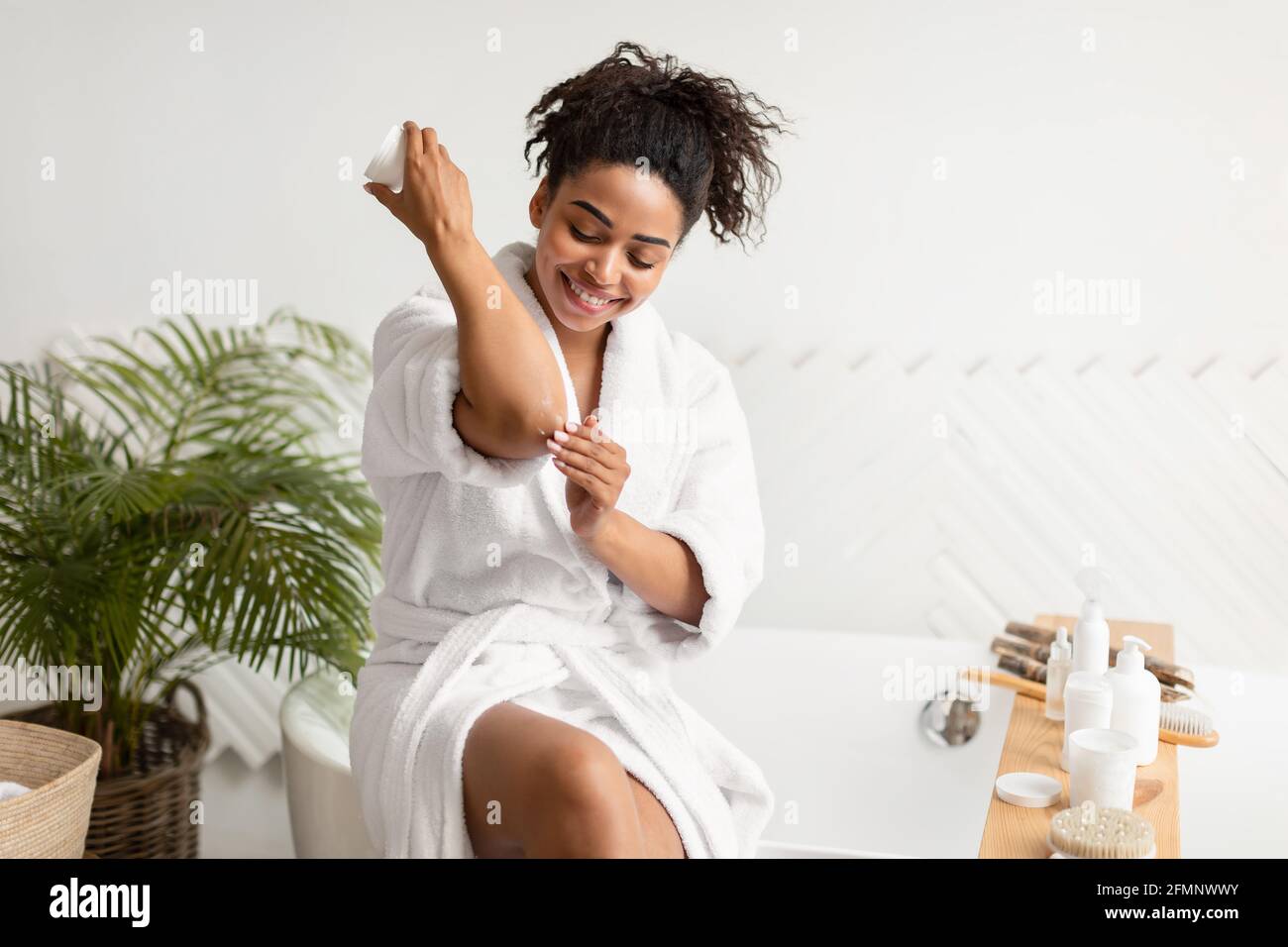African Lady Applying Cream On Elbows Caring For Skin Indoor Stock ...