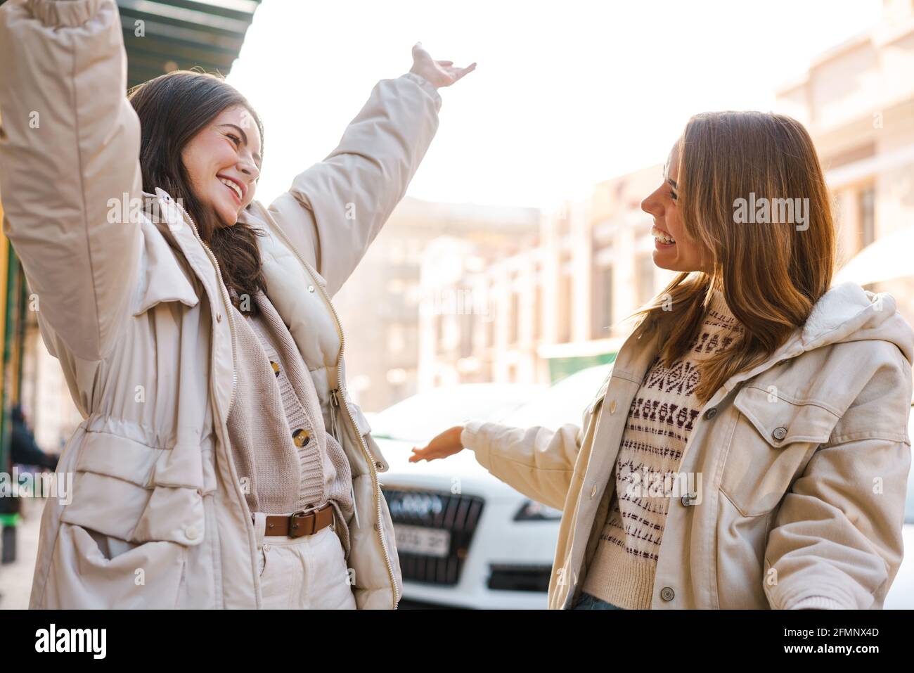 Happy meeting of two girlfriends in the street Stock Photo - Alamy