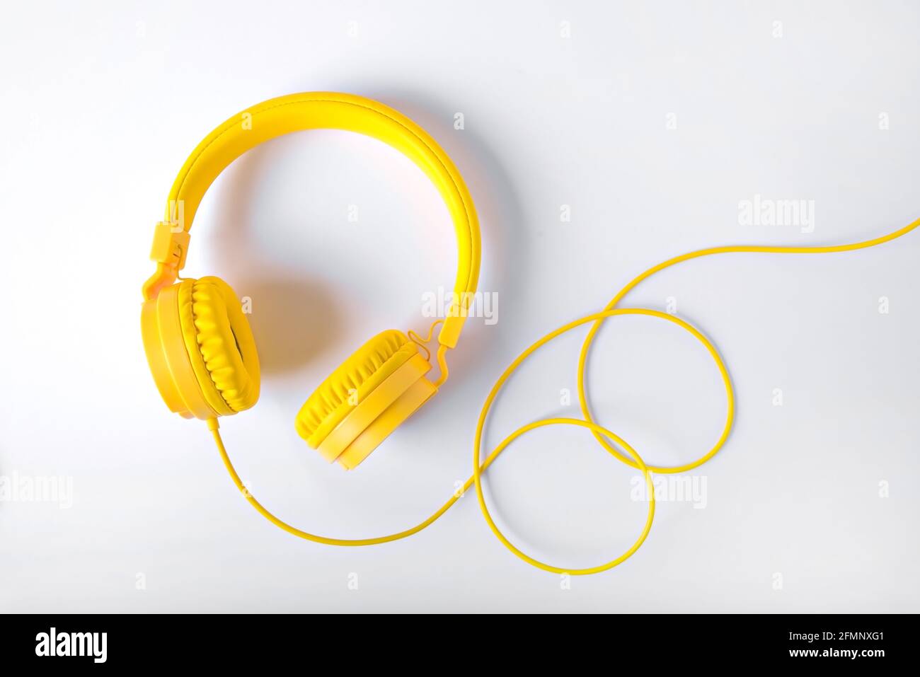 Yellow wired headphones on a white background Stock Photo - Alamy