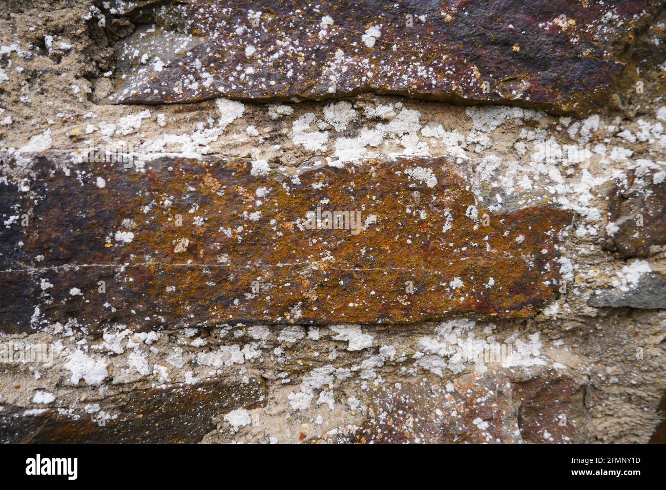 macro shot of a medieval castle wall made from old brown stone bricks ...