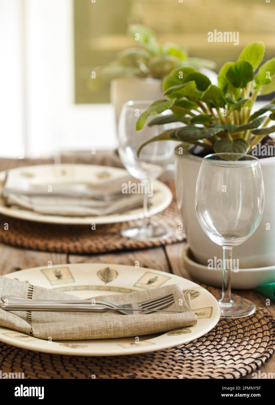 Table setting with plant decor Stock Photo - Alamy