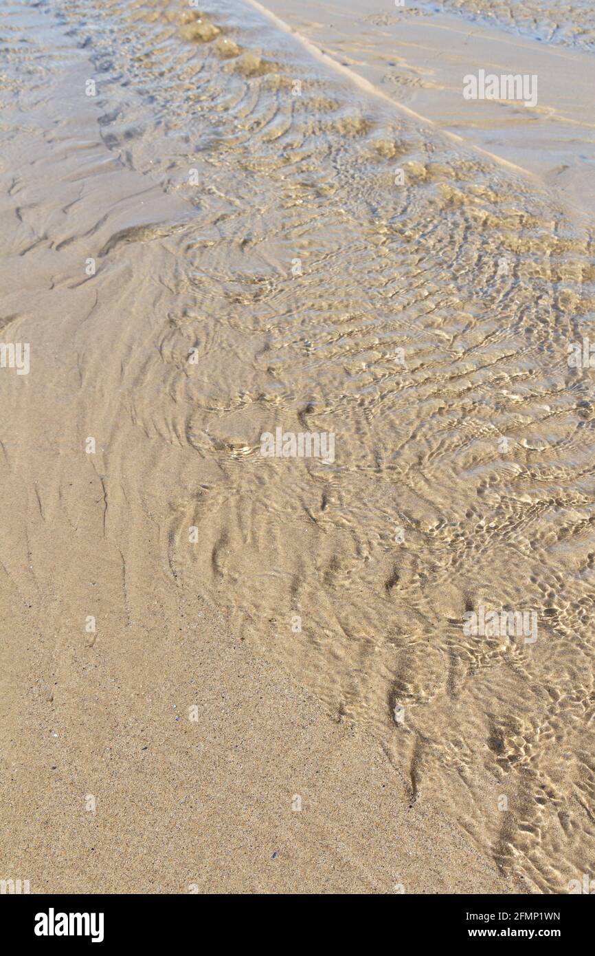 Water flowing on the sand of a beach in Brittany Stock Photo - Alamy